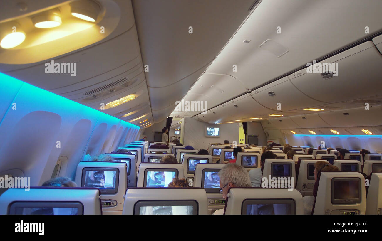 Interior passengers airplane with people on seats. Aircraft cabin with ...