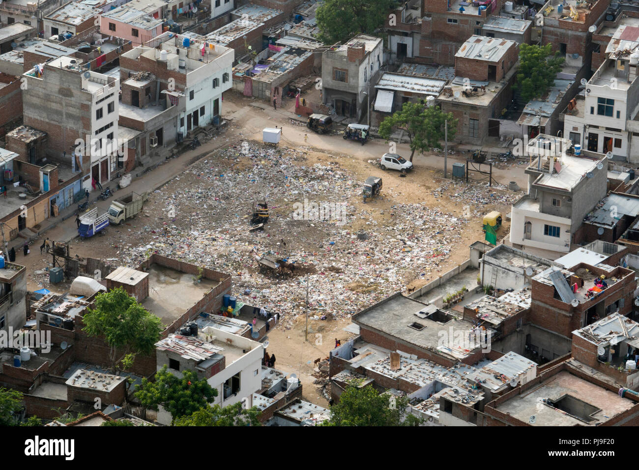 Slum area with public square covered in plastic trash in Jaipur ...