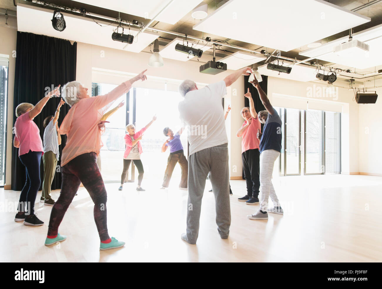 Active seniors dancing, exercising and stretching in circle Stock Photo ...