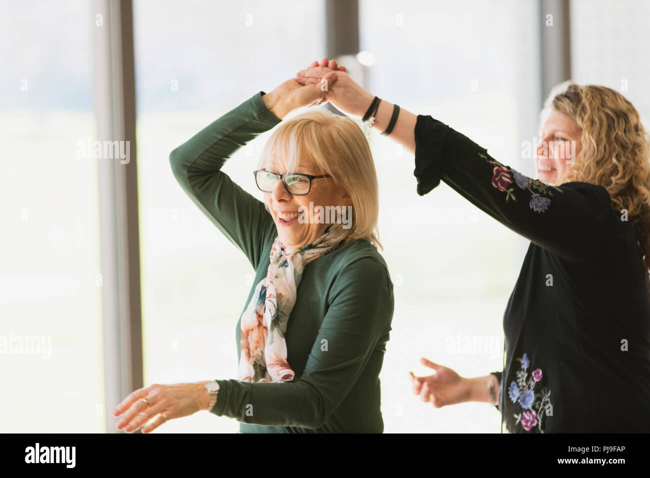 Smiling active senior woman dancing Stock Photo - Alamy