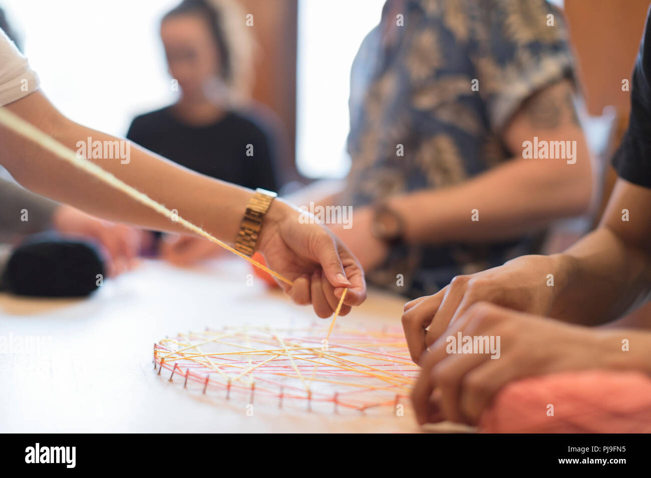 People doing string art project Stock Photo - Alamy
