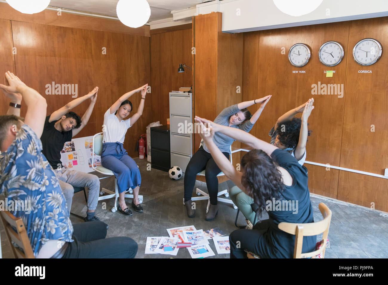 Creative business people stretching, taking a break in meeting Stock ...
