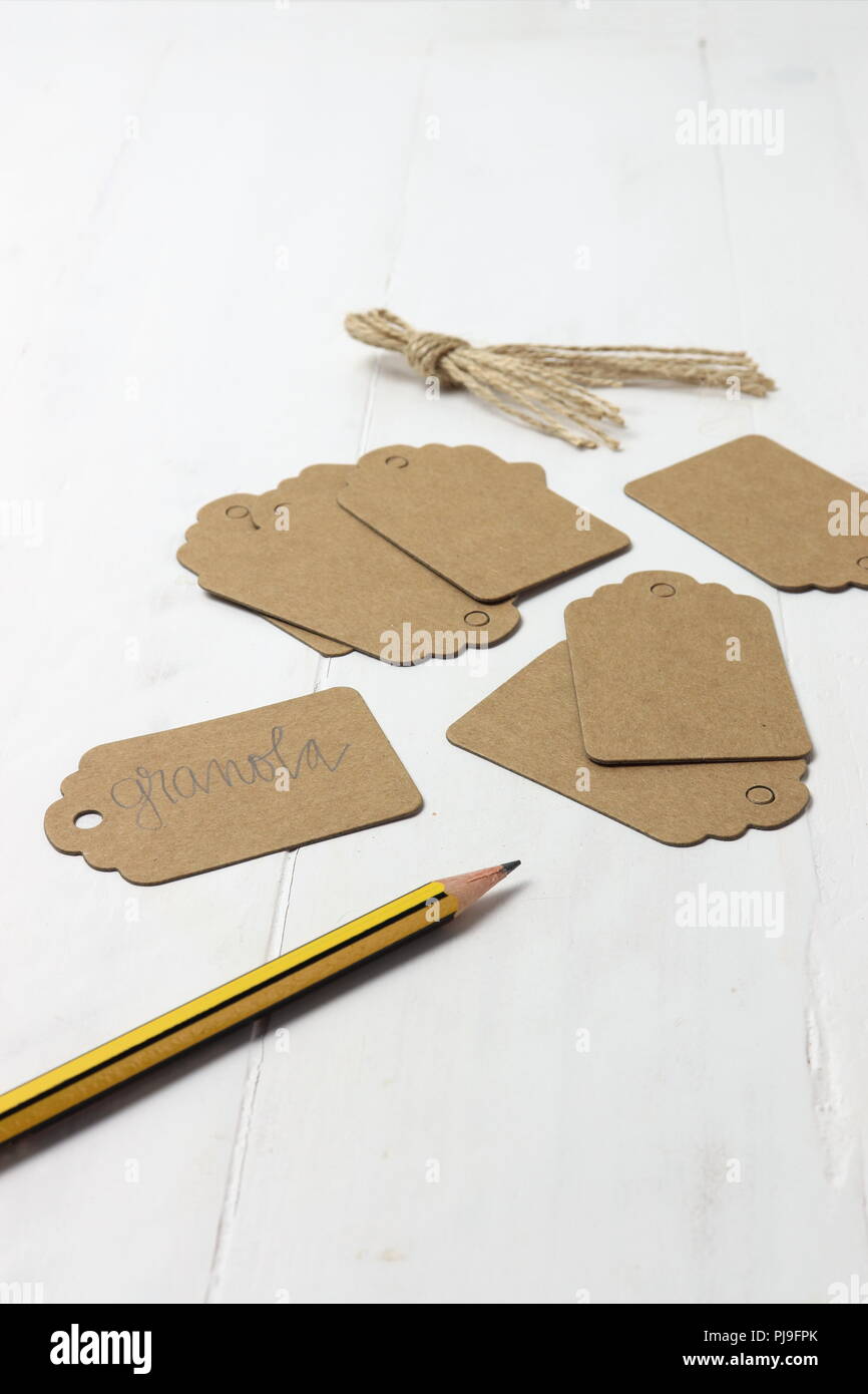 Carton tags on white surface Stock Photo - Alamy