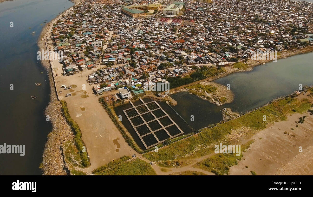 Aerial view poor district of Manila slums, ghettos, wooden old houses ...