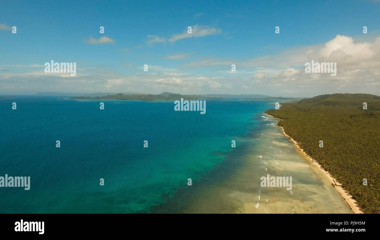 Coastline of the tropical island Siargao with the mountains and the ...