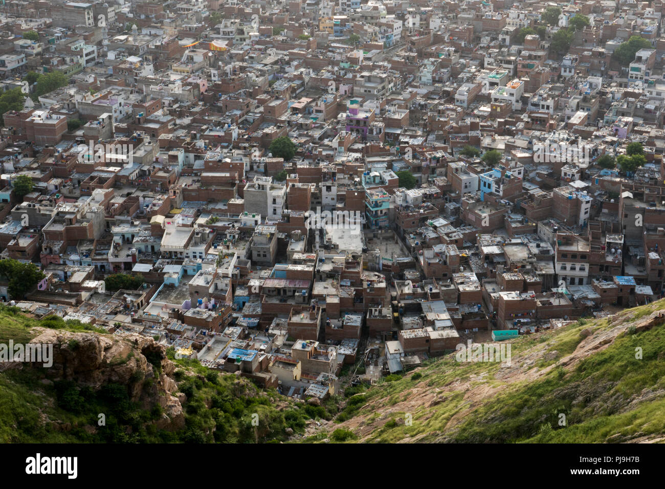 Slum area at the base on the Aravalli hills in Jaipur, Rajasthan, India ...