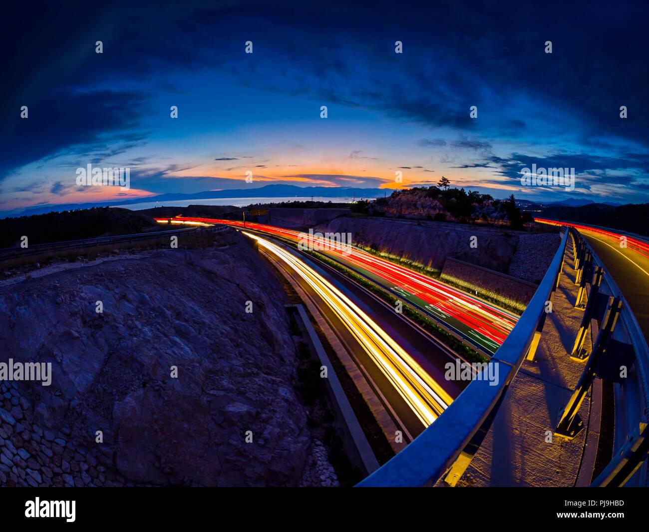 Light trails on curved road at night hi-res stock photography and ...