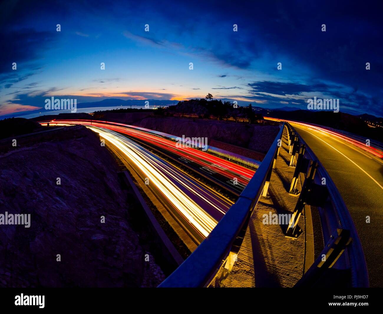 Light trails on curved road at night hi-res stock photography and ...