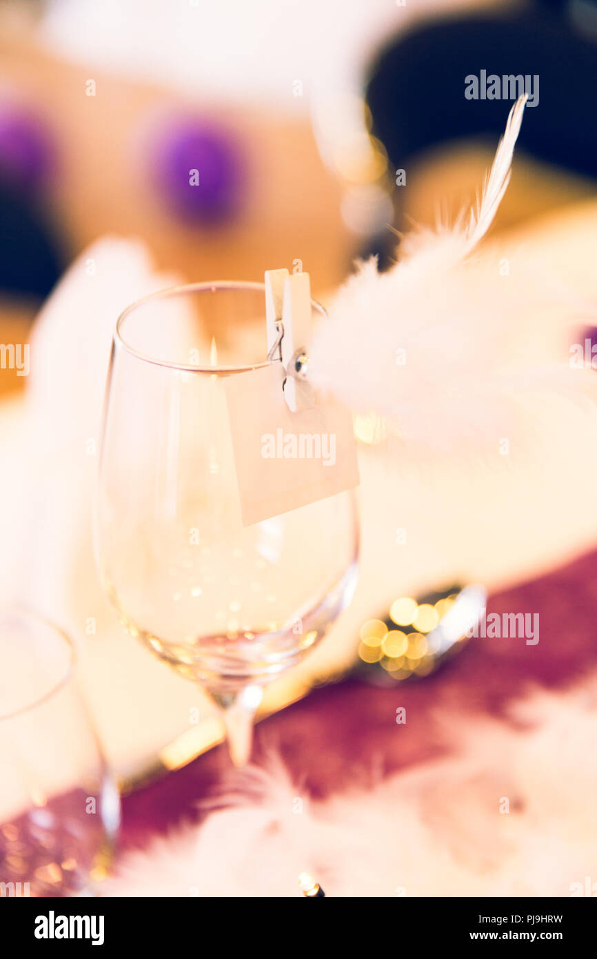 Wine Glass Feather Name Tag on Wedding Table Stock Photo - Alamy
