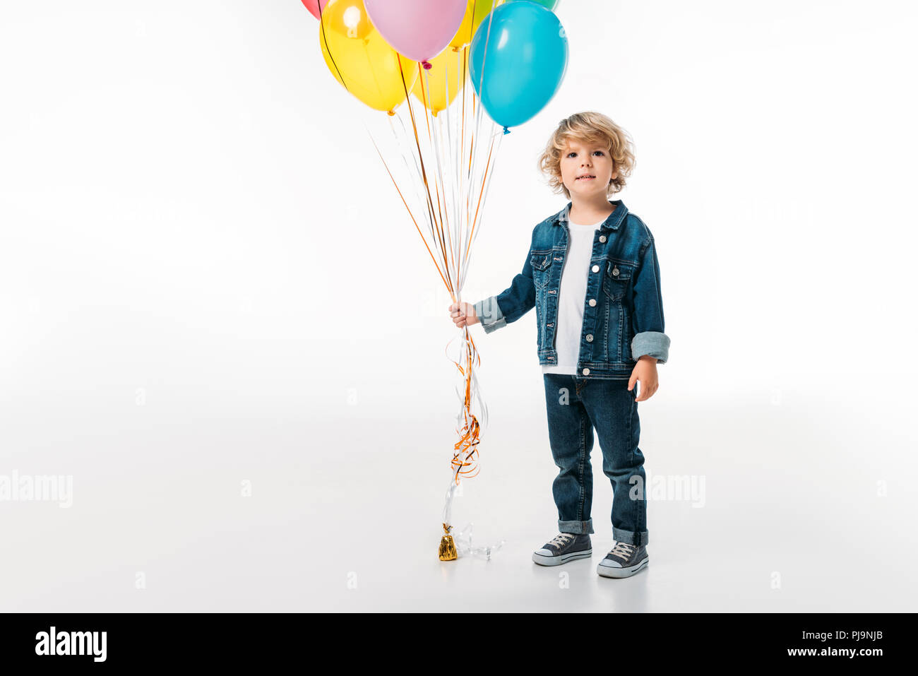 adorable boy holding bundle of colored balloons isolated on white Stock ...