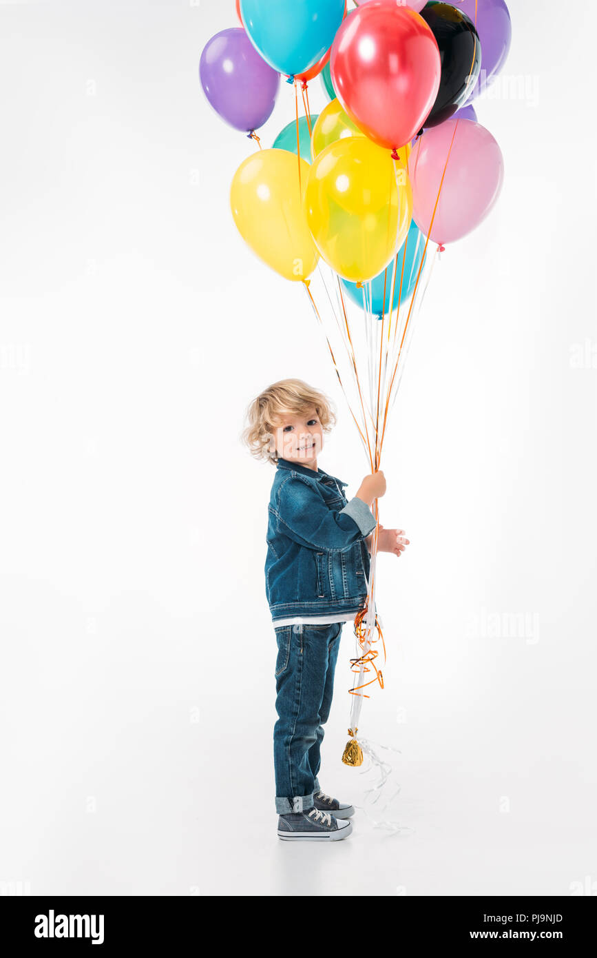 smiling adorable boy with bundle of balloons isolated on white Stock ...
