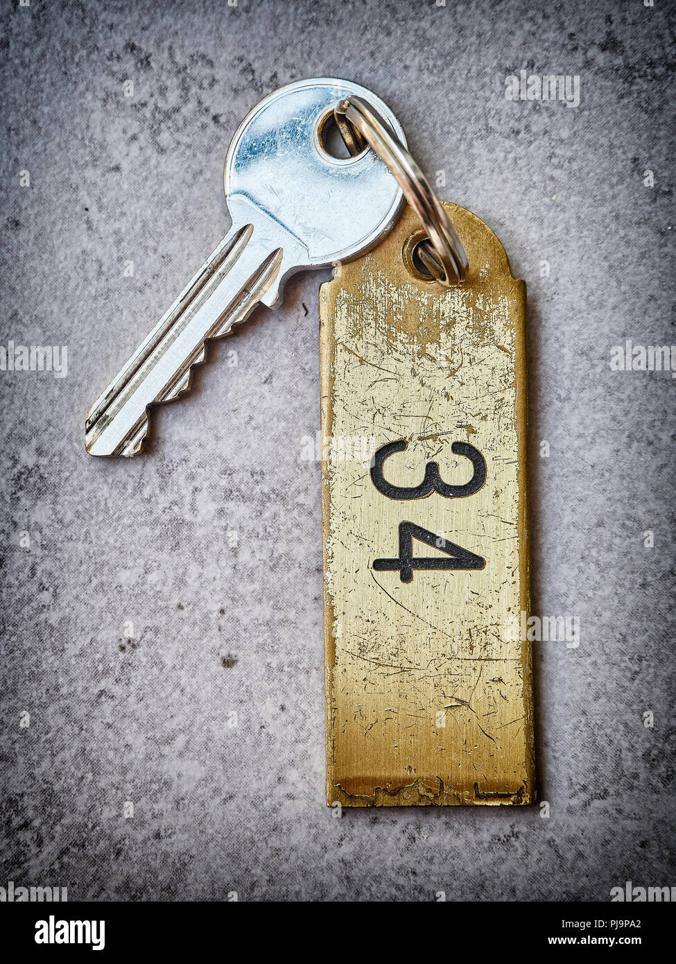 Hotel key over a stone background with the key chain number 34 Stock ...