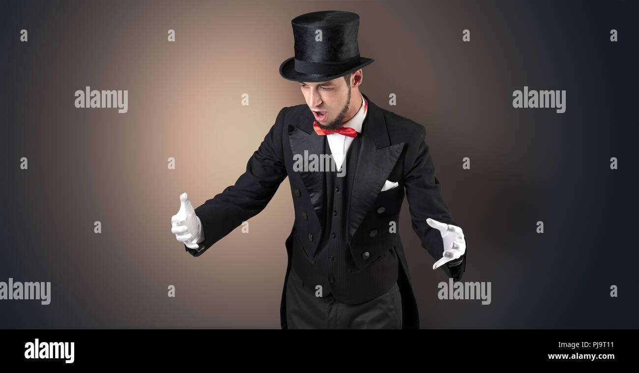 Handsome magician with no graph holds something invisible Stock Photo ...