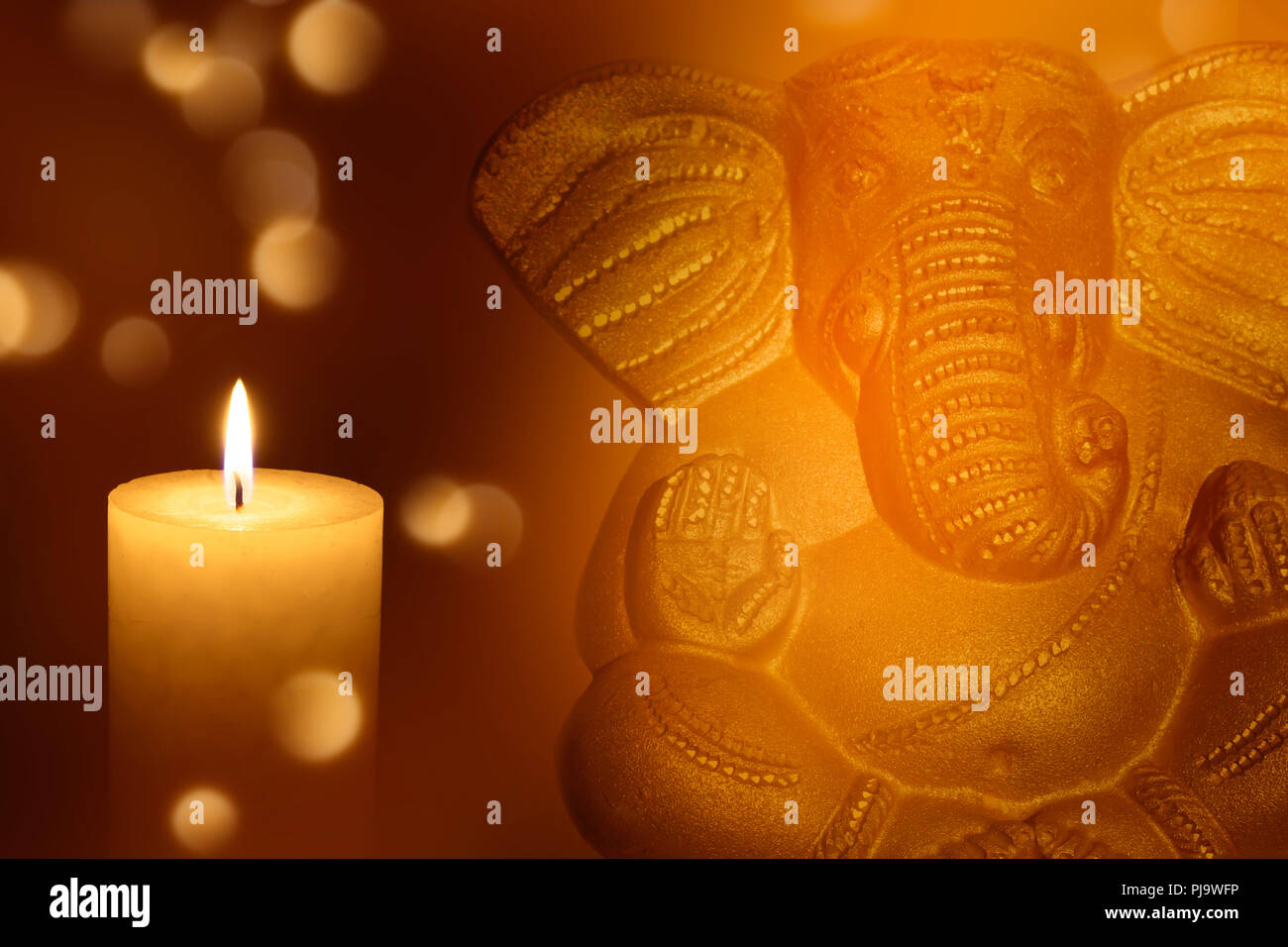 ganesh statue with shiny candle light Stock Photo - Alamy