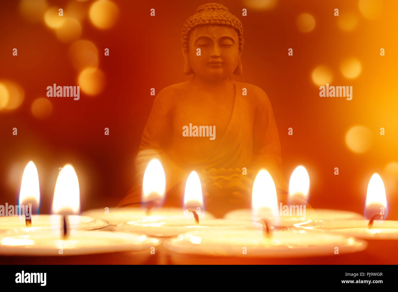 buddha statue with shiny tea lights Stock Photo - Alamy