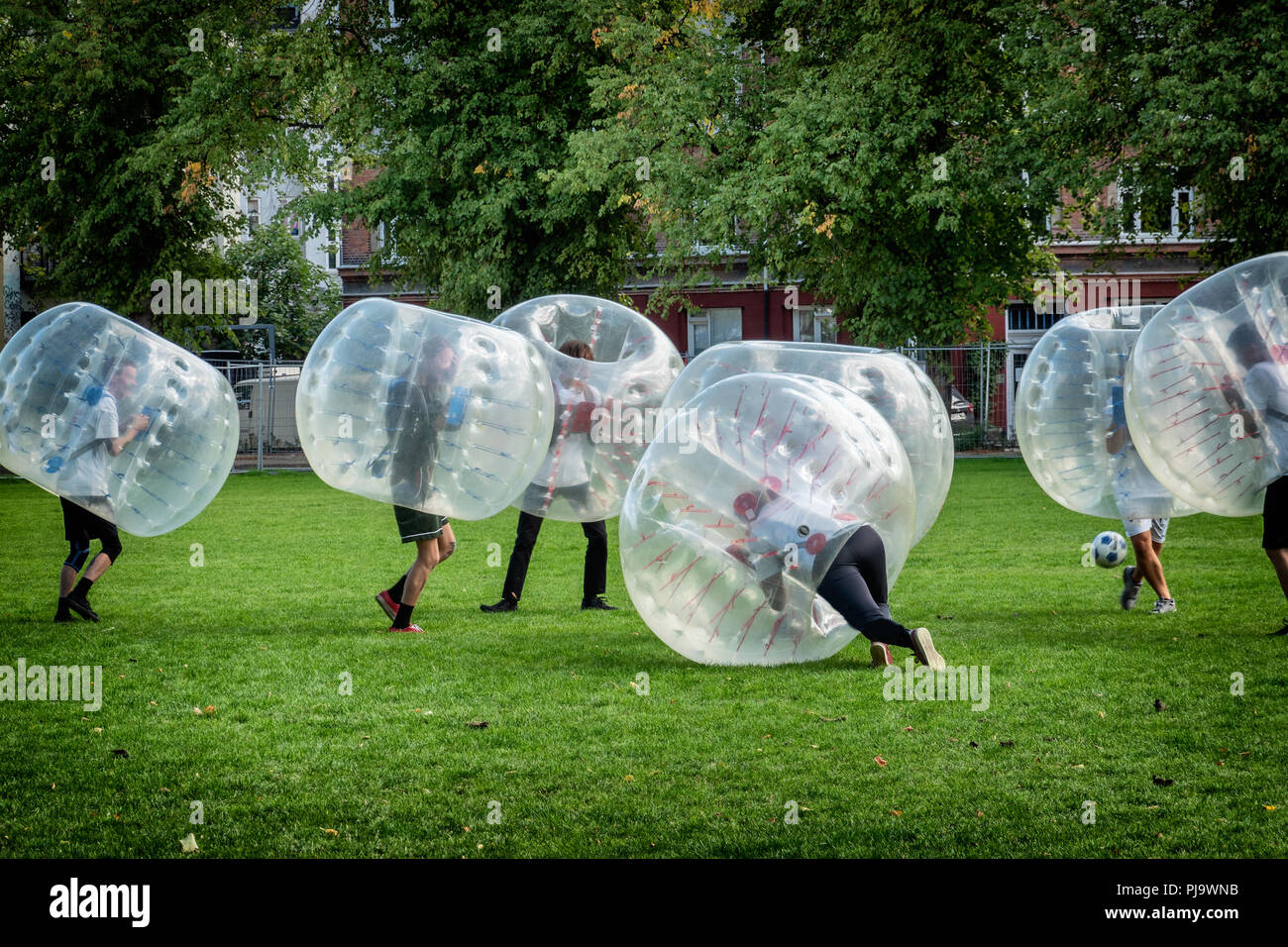 Bumper football soccer on a green field Stock Photo - Alamy