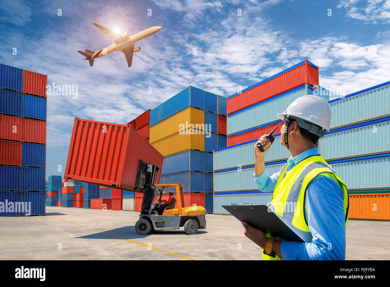 Crane lifting up container in yard Stock Photo - Alamy