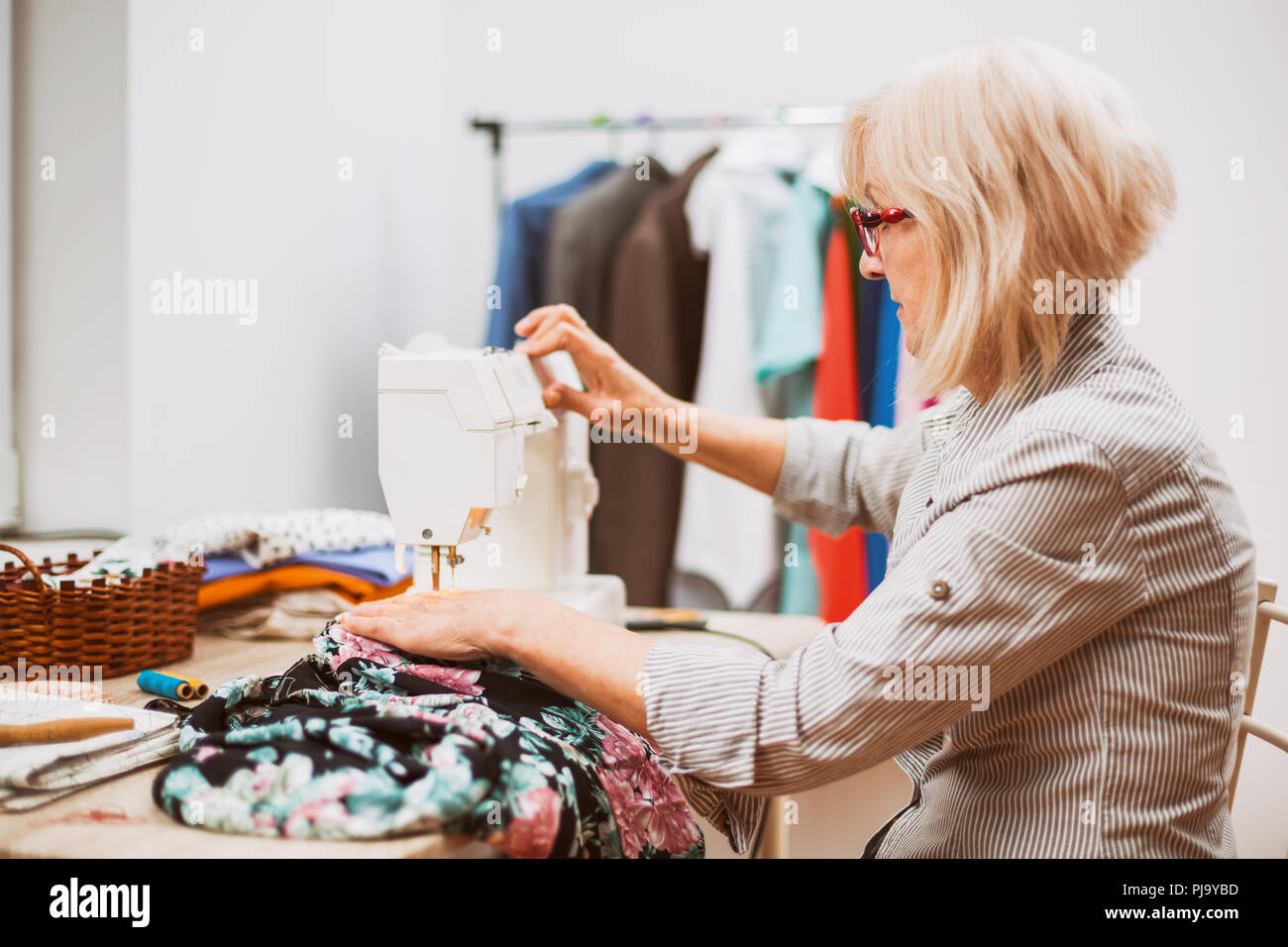 Beautiful seamstress blonde in sewing hi-res stock photography and ...