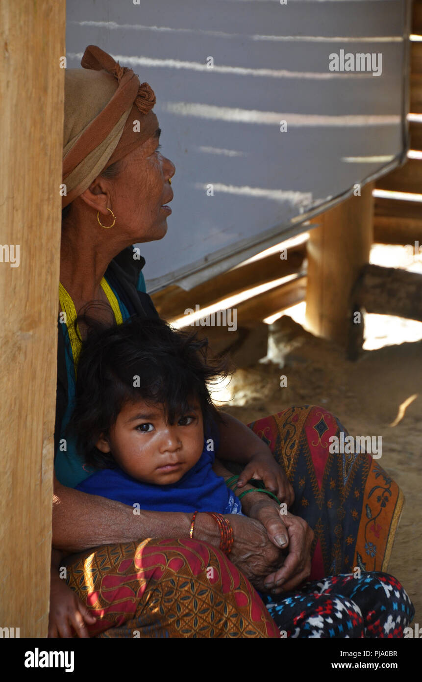 A Dalit (untouchable) girl sits in her mother's lap in the village of ...