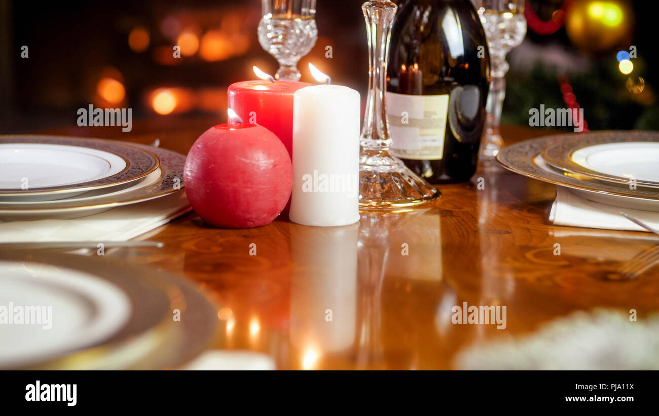 Closeup image of burning candles on dining table served for romantic ...