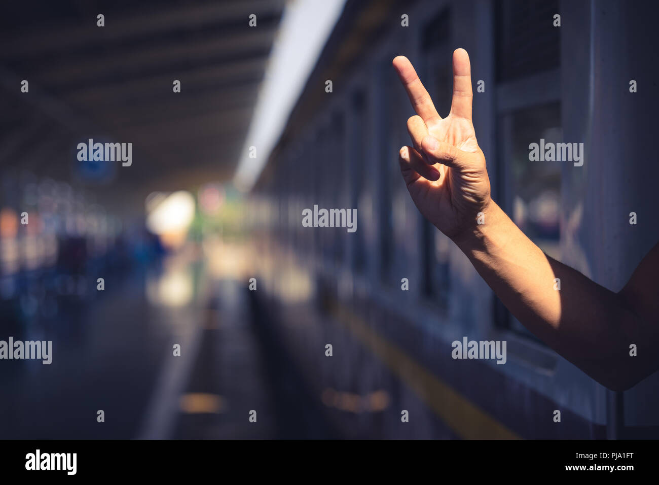 tourist showing peace hand sign on the train Stock Photo - Alamy
