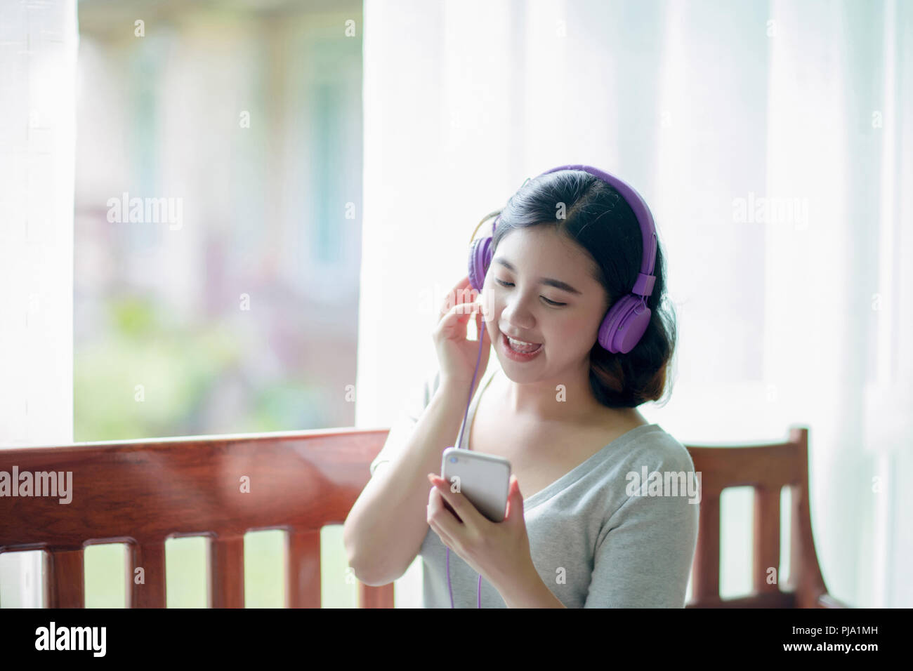 Young asian girl listening the music with happiness Stock Photo - Alamy