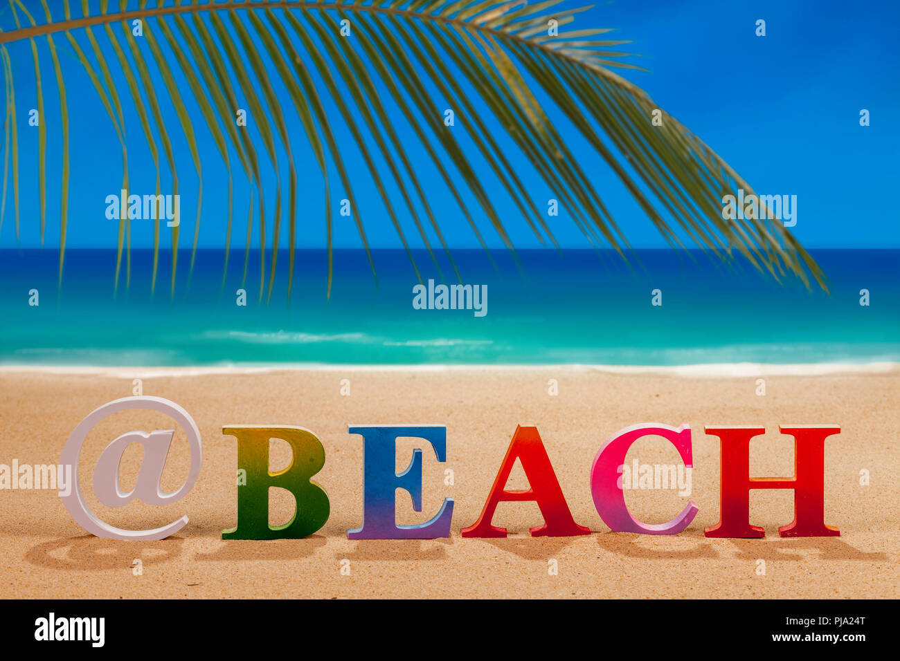 beach written in colorful wood letters with sea shell at the beach with ...