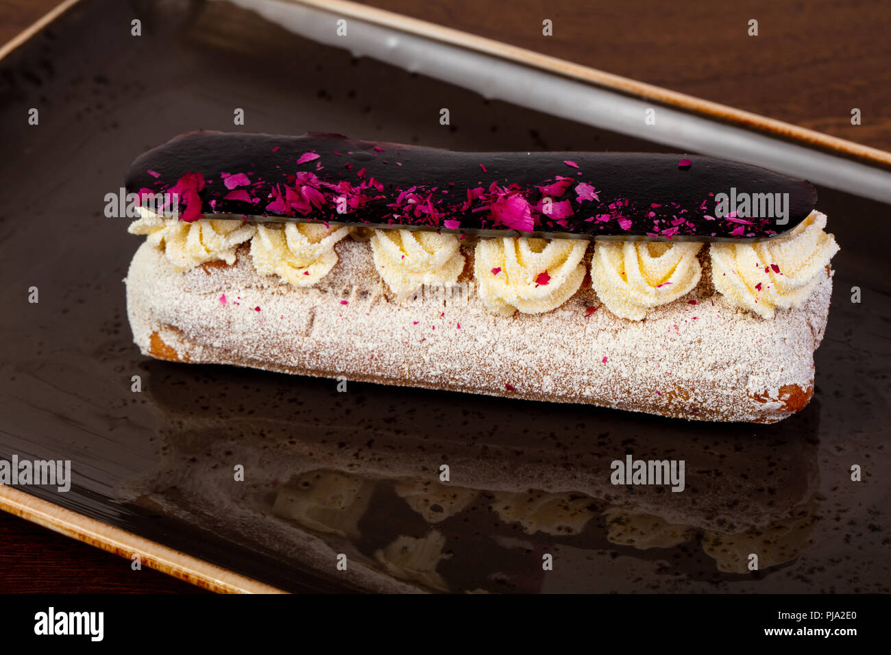 Tasty sweet Eclair with cream Stock Photo - Alamy