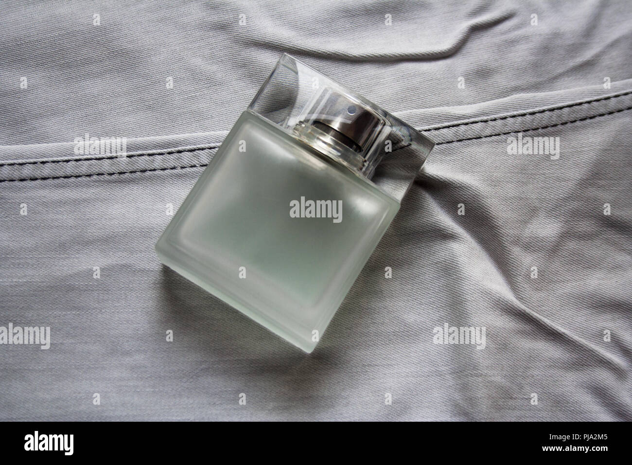 Rectangular perfume bottle with frosted glass effect on light grey ...