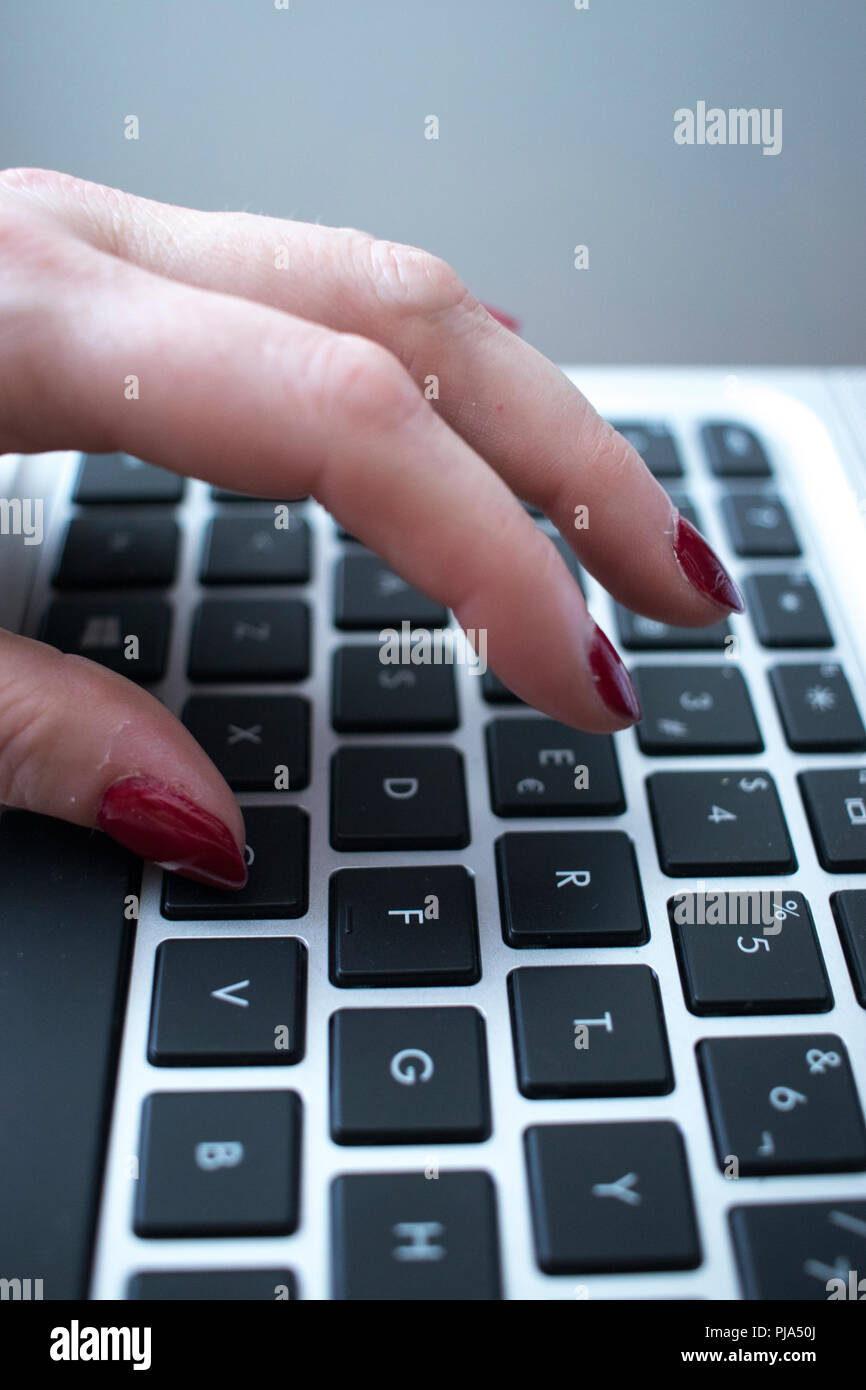 Secretary typist typing on laptop pc computer keyboard keys with hands ...