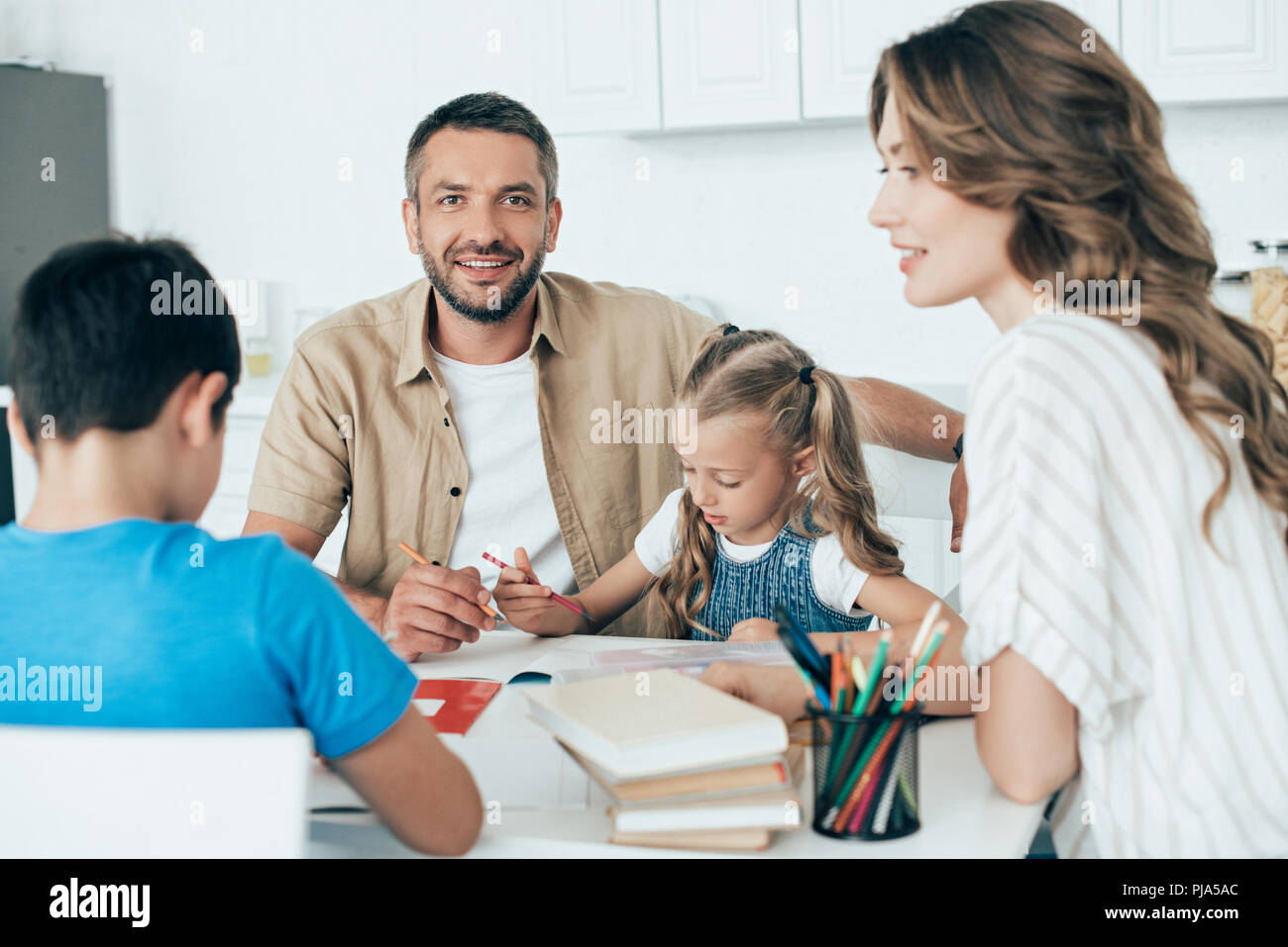 Parents help kids study hi-res stock photography and images - Alamy