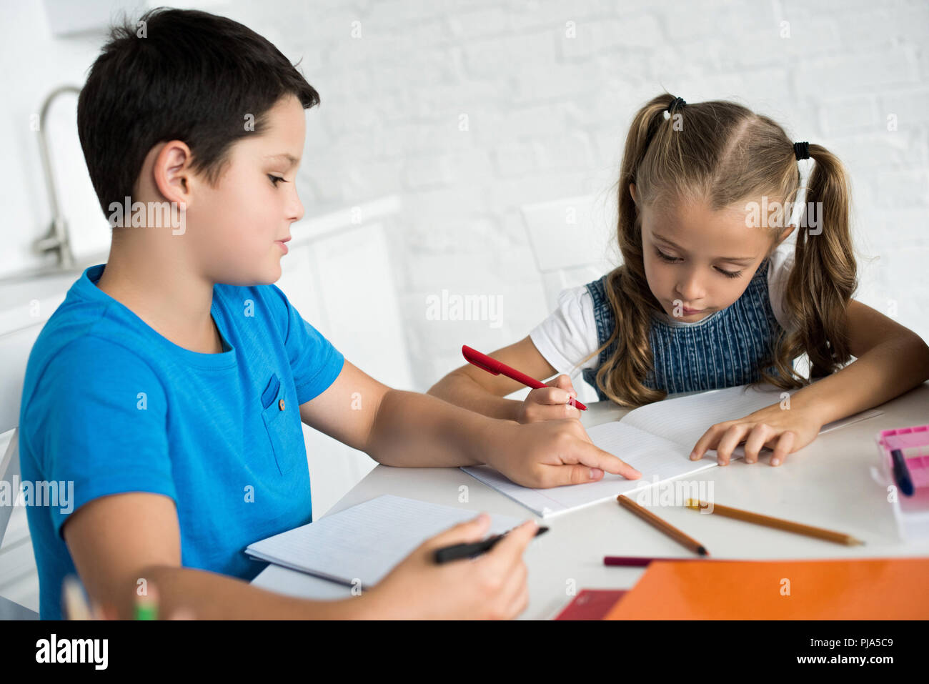 Brother sister doing homework together hi-res stock photography and ...