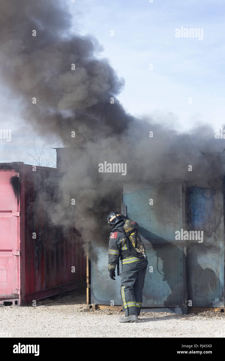 Firefighter putting out fire training station extinguisher backdraft ...