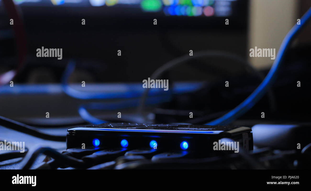 Close-up of a black USB hub with number indicator lights ON ...