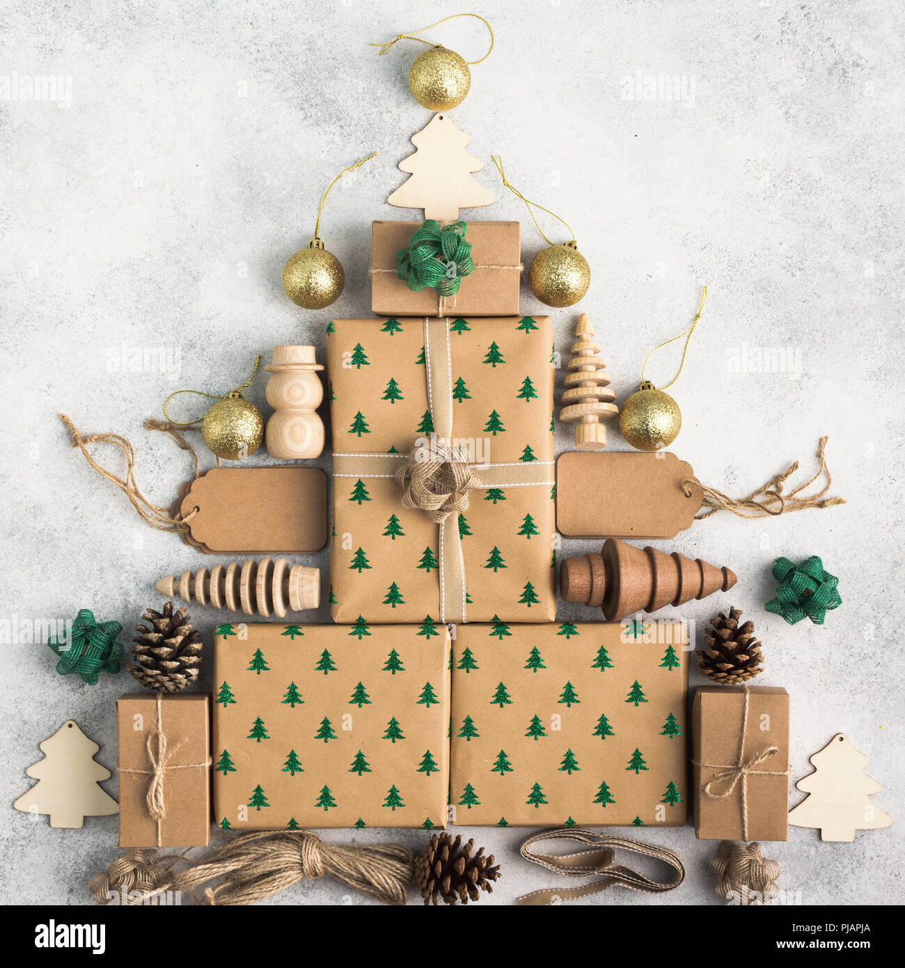 Christmas tree made of brown present boxes, pine cones, jute twine ...