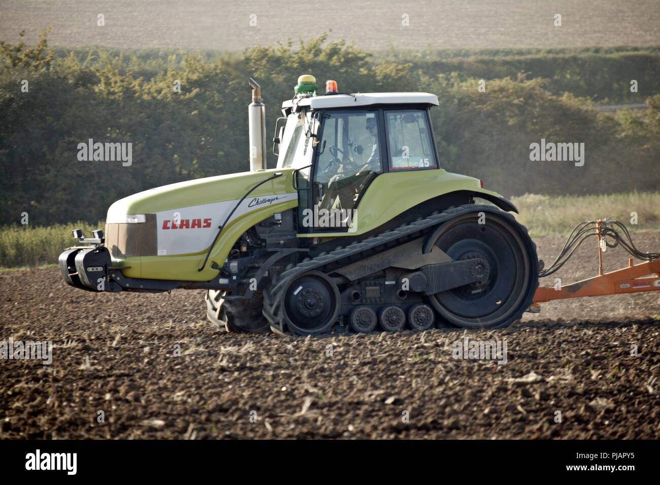 Tractor cultivating after harvest Stock Photo - Alamy