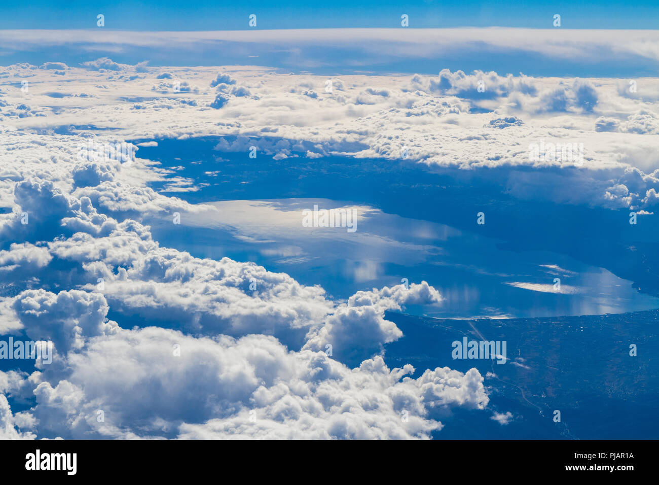 Aerial view of unique bodies of cumulus thunderstorm clouds over a lake ...