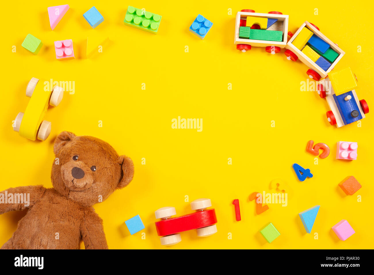 Baby kids toys background with teddy bear, wooden train, colorful ...