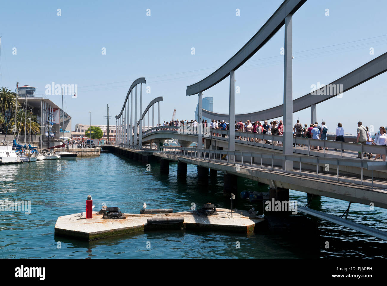 A large number of people crossing the Rambla De Mar bridge in the port ...