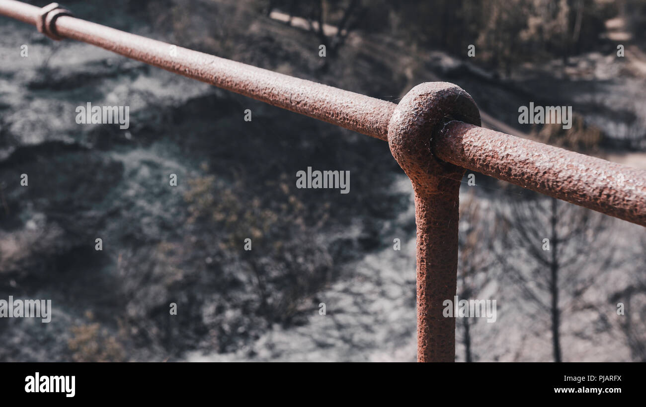 Railing with rust and black background of the burnt forest Stock Photo ...