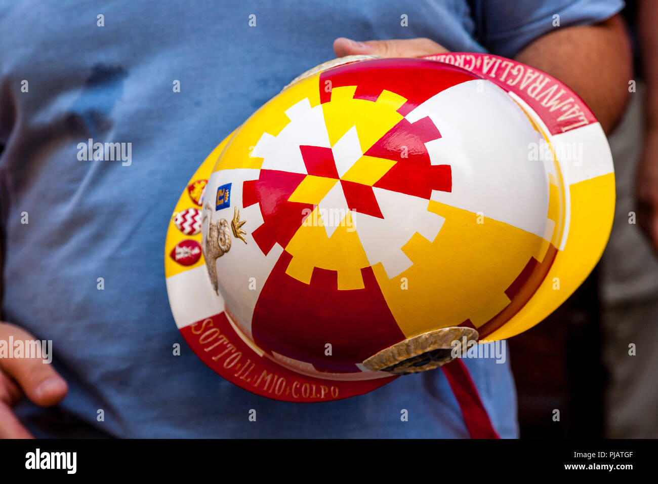 A Man From The Valdimontone (Ram) Contrada Holds The Helmet Worn By The ...