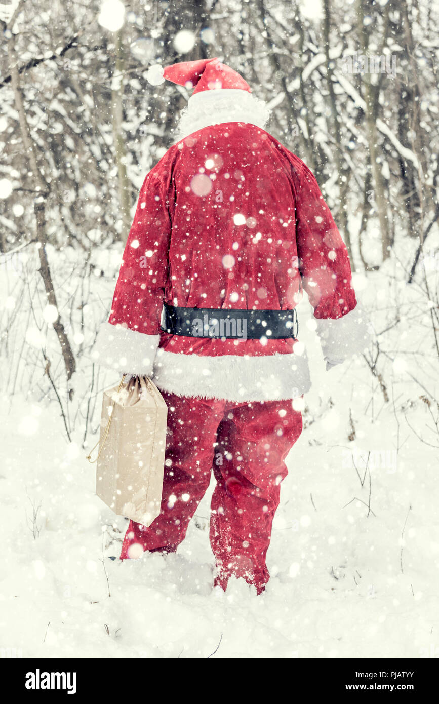 Santa Claus walking in the woods and holding presents Stock Photo - Alamy