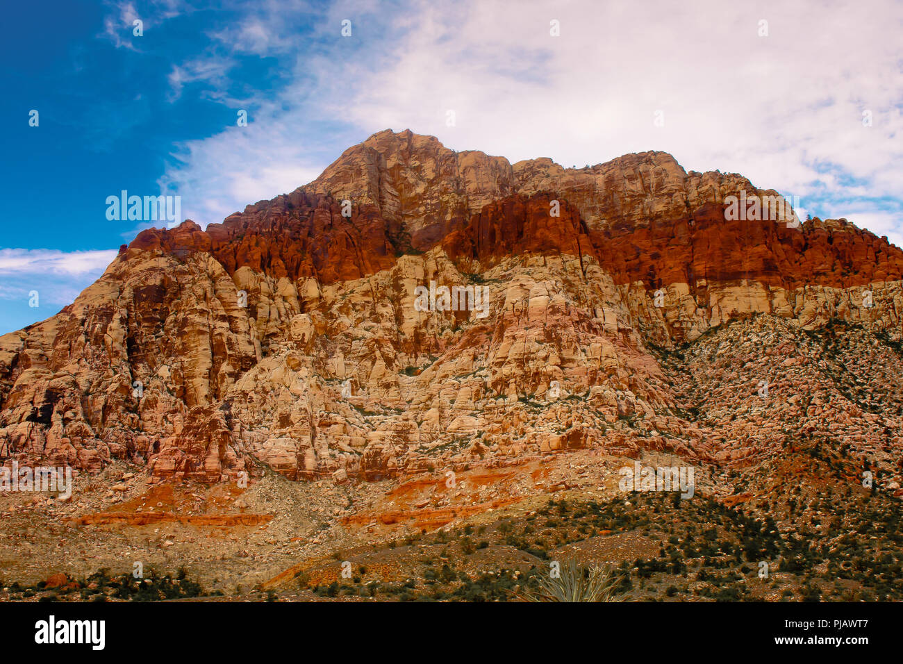 Mountains rising from the desert floor with many bands of colors Stock ...
