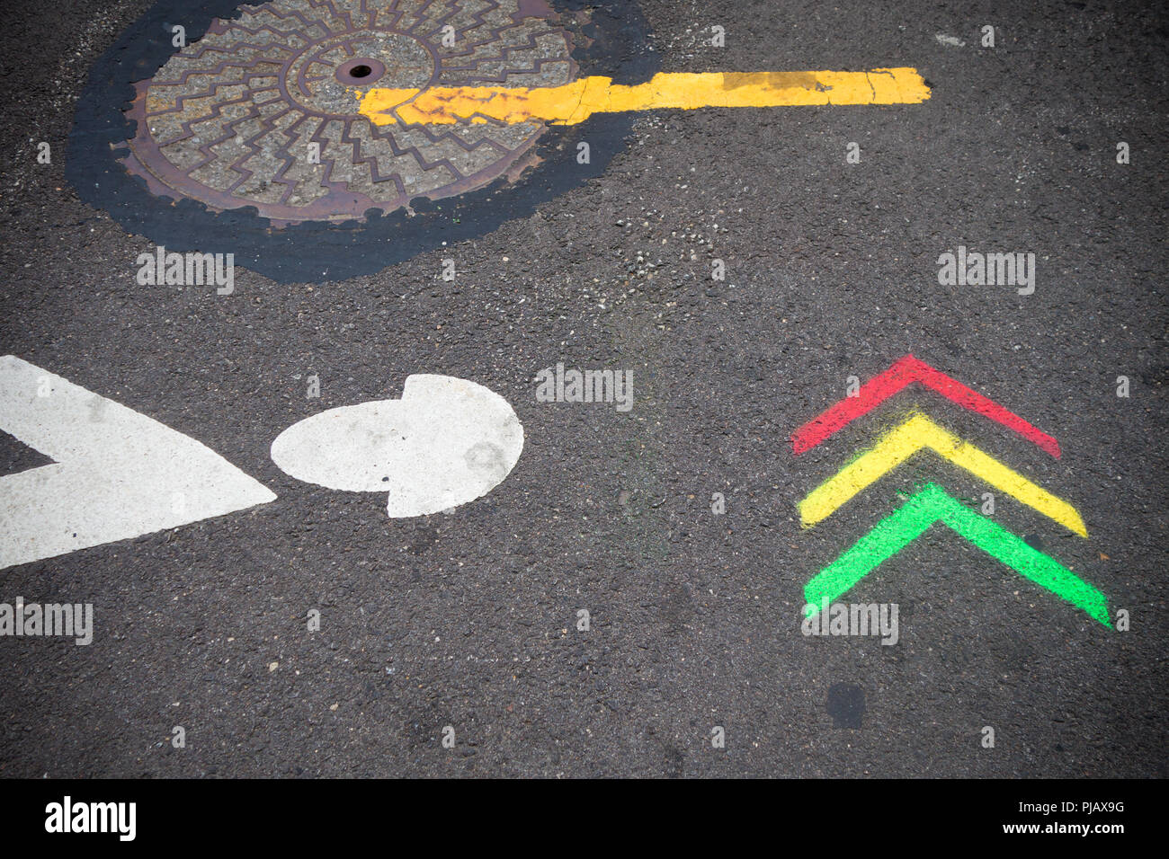 Red, yellow and green arrows painted on pavement Stock Photo - Alamy