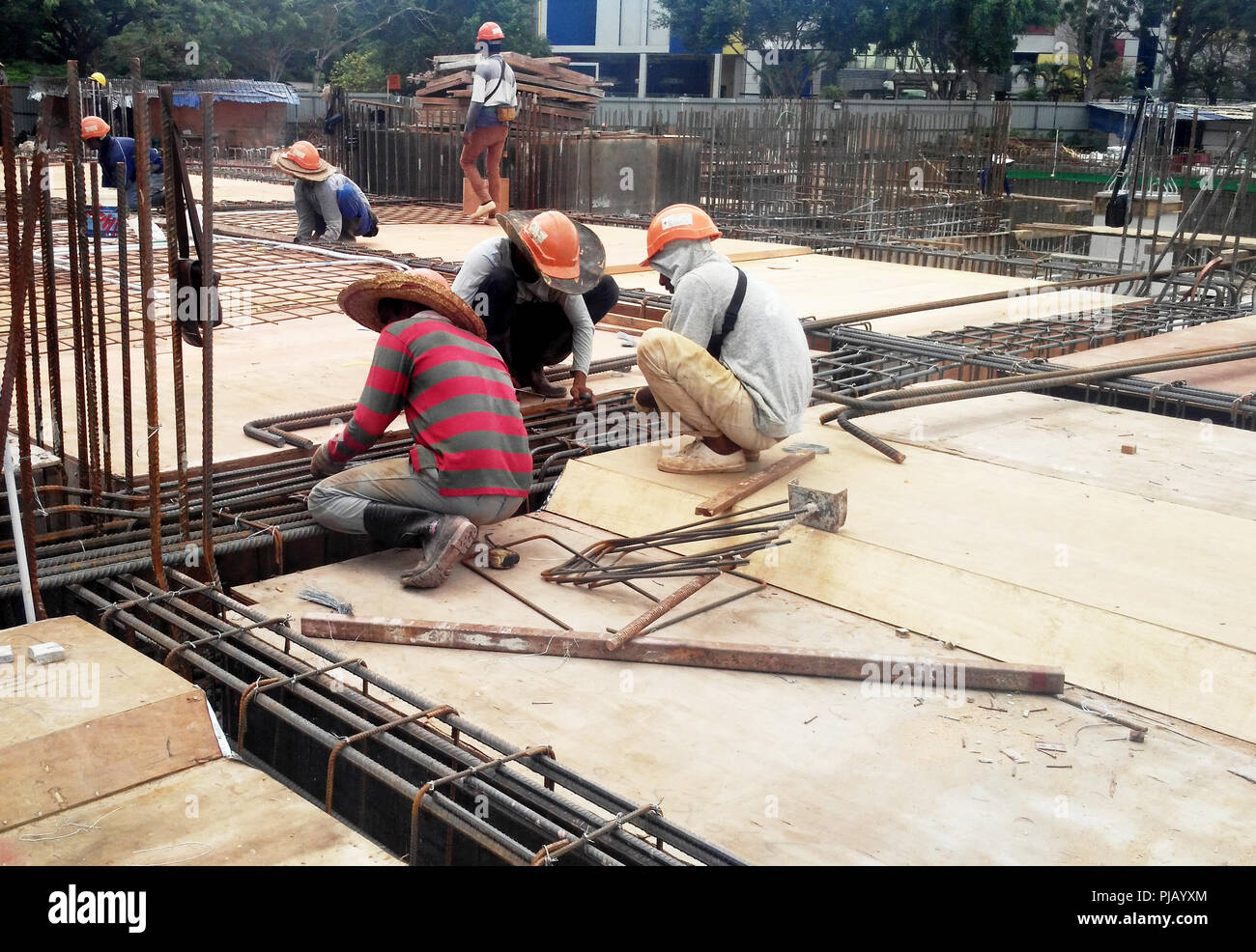 Construction workers installing reinforcement bar at the construction ...