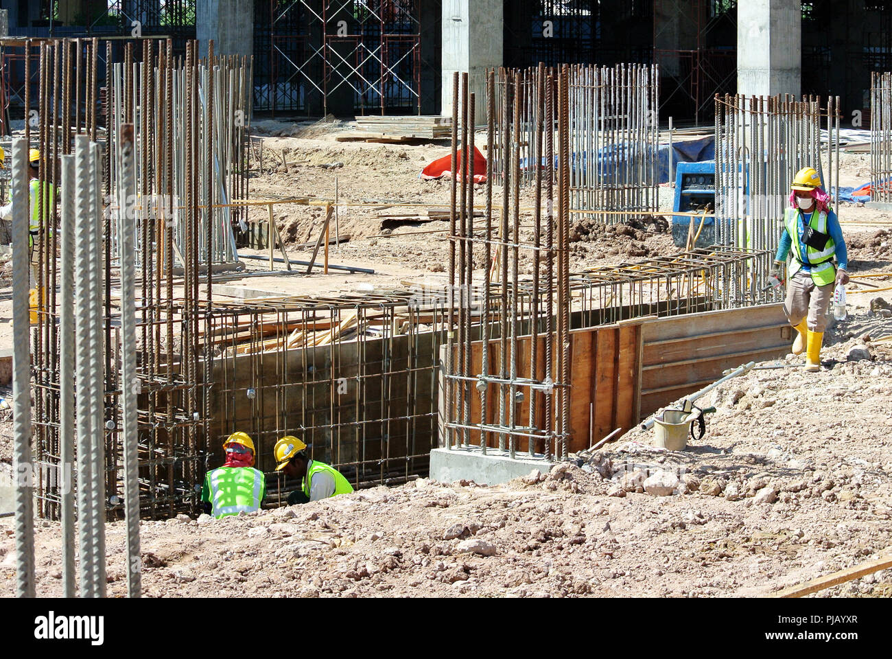 Construction workers installing reinforcement bar at the construction ...