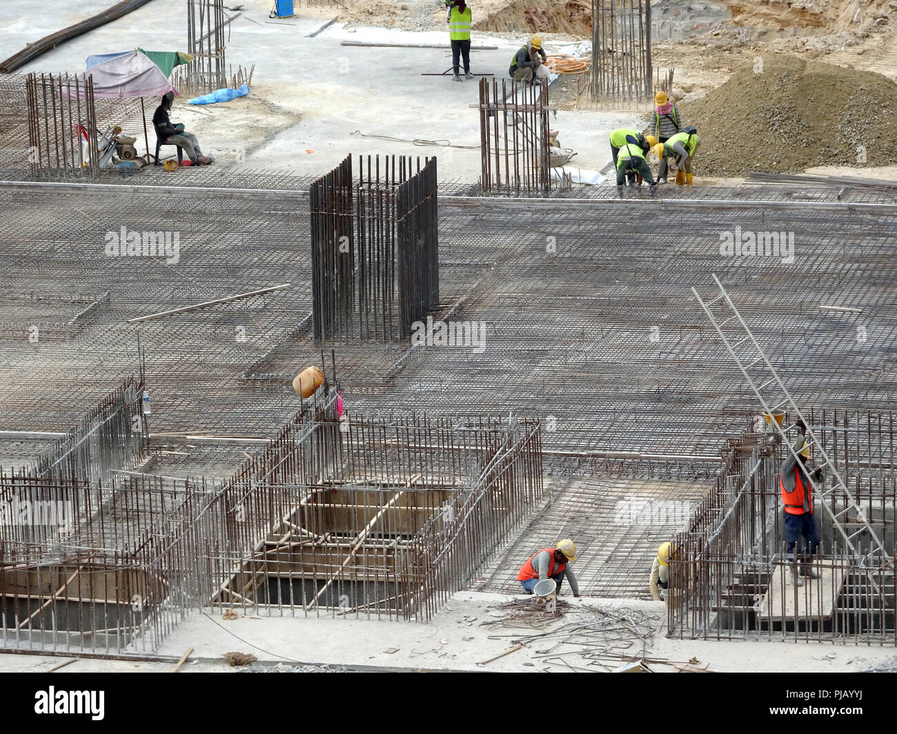 Construction workers installing reinforcement bar at the construction ...
