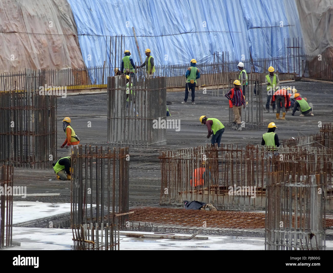 Construction workers installing reinforcement bar at the construction ...