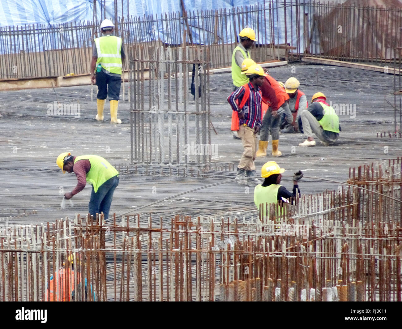 Construction workers installing reinforcement bar at the construction ...