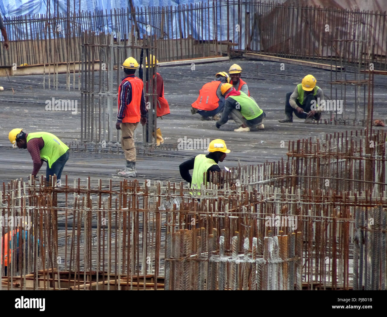 Construction workers installing reinforcement bar at the construction ...
